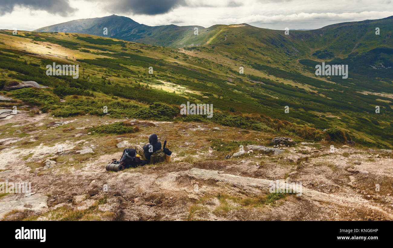 Traveler with backpack and mountain panorama Stock Photo - Alamy