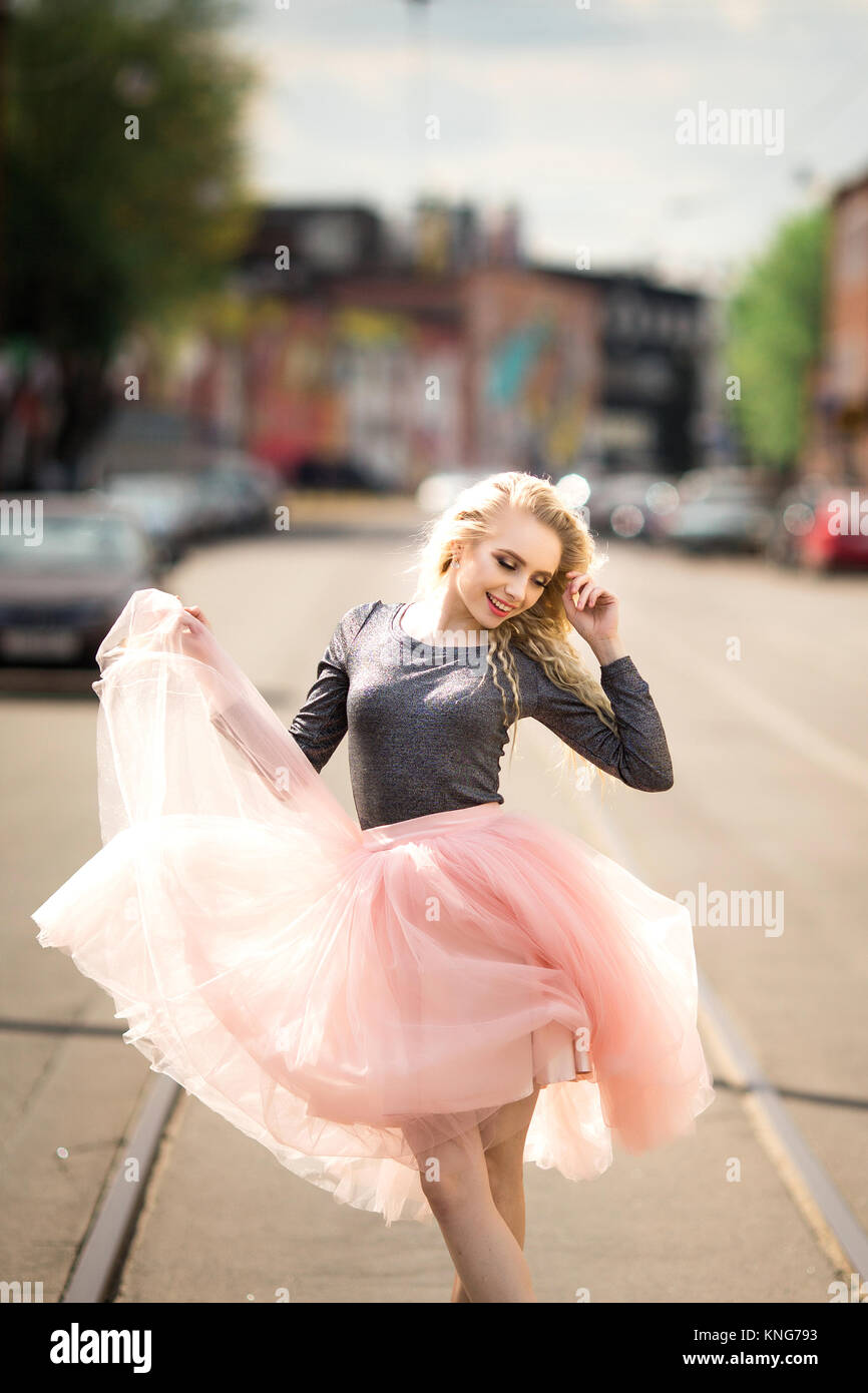 A beautiful women is walking along the street Stock Photo - Alamy