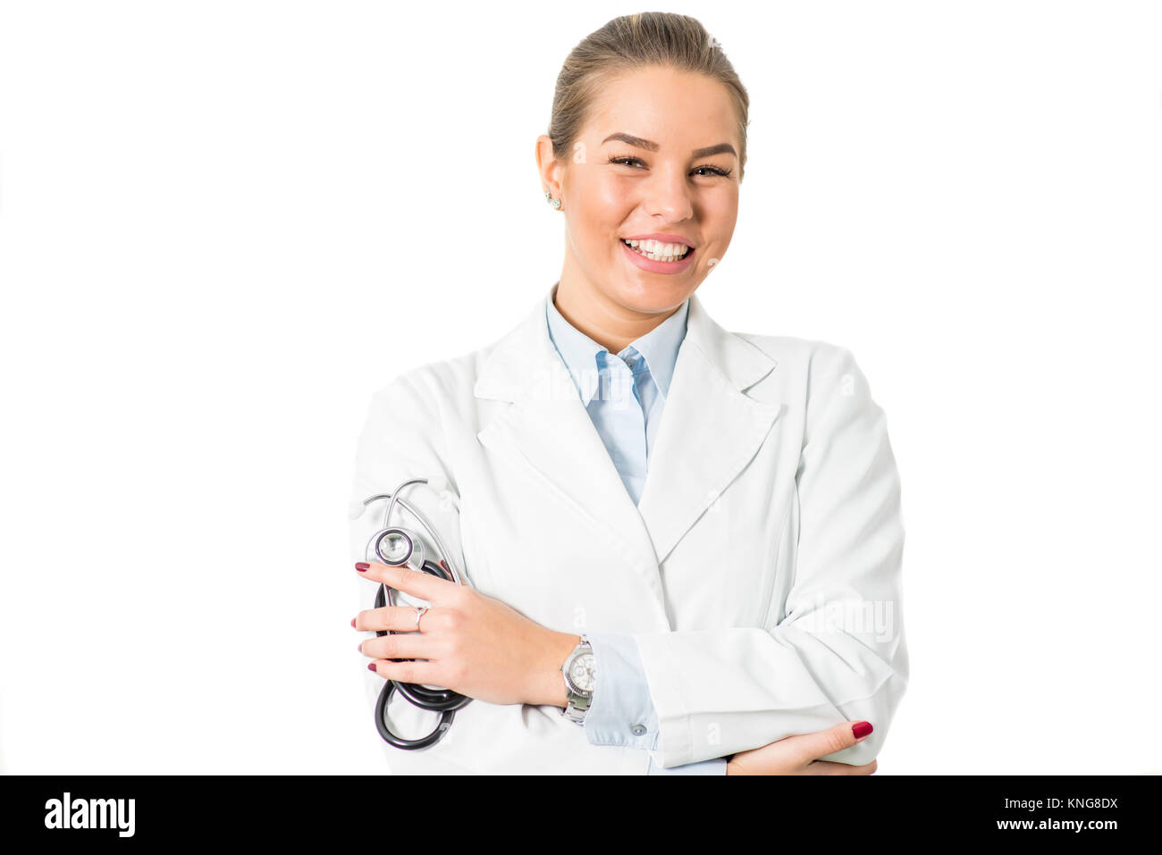 Pretty smiling young female doctor by the white wall Stock Photo - Alamy