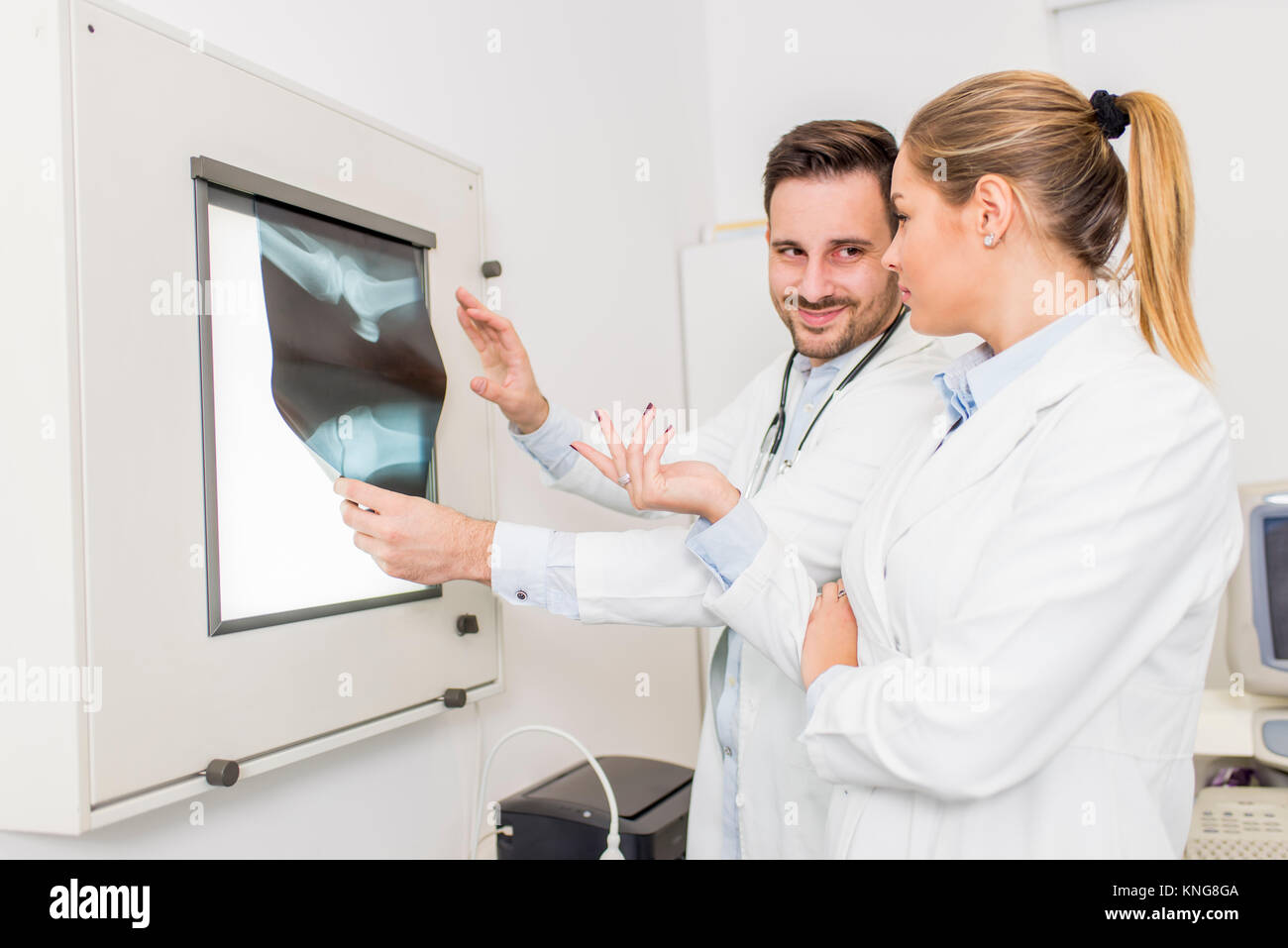 Doctors examining an x-ray of the patient at clinic Stock Photo - Alamy