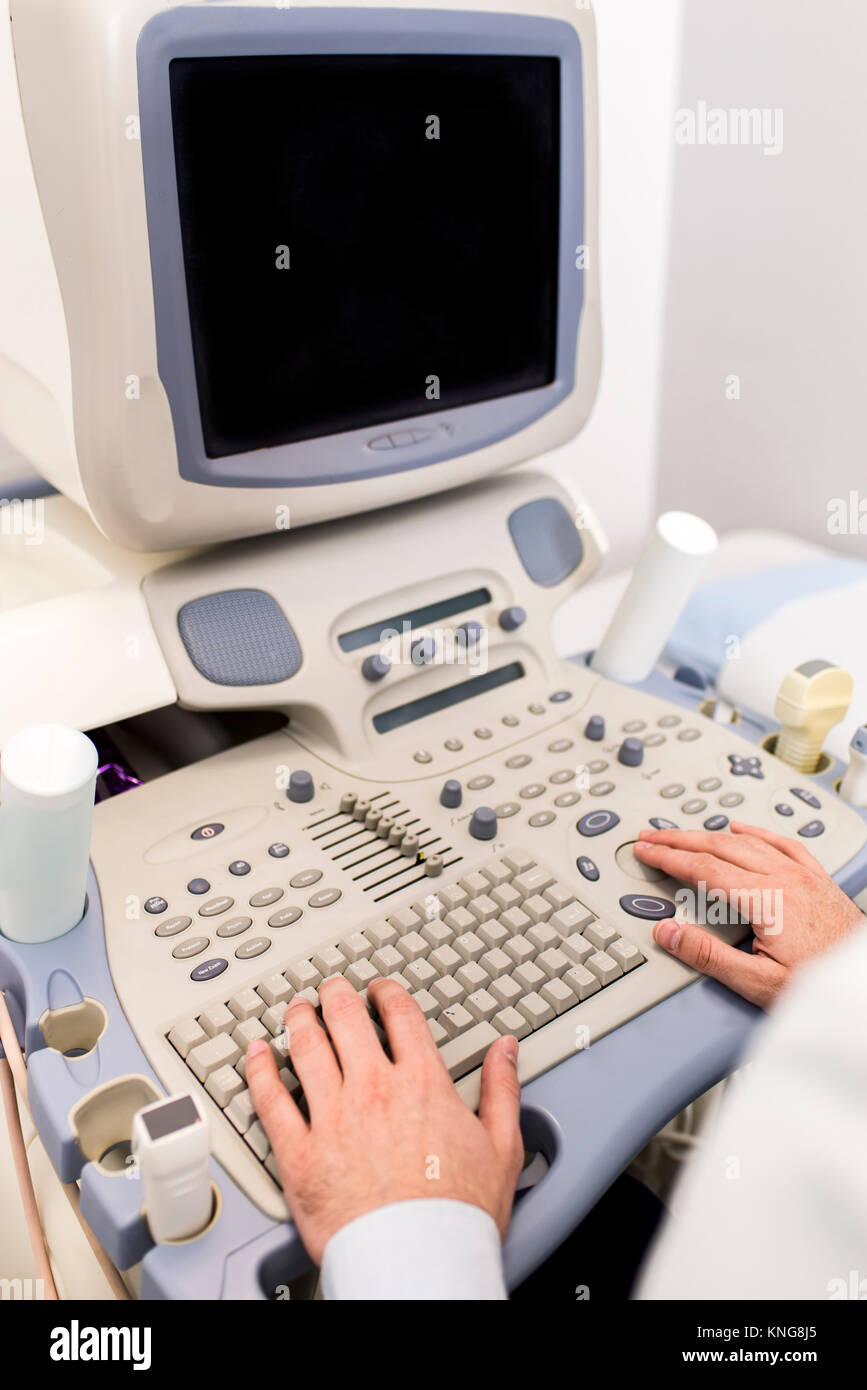 Close up view at doctors hands working on ultrasounds keyboard Stock ...