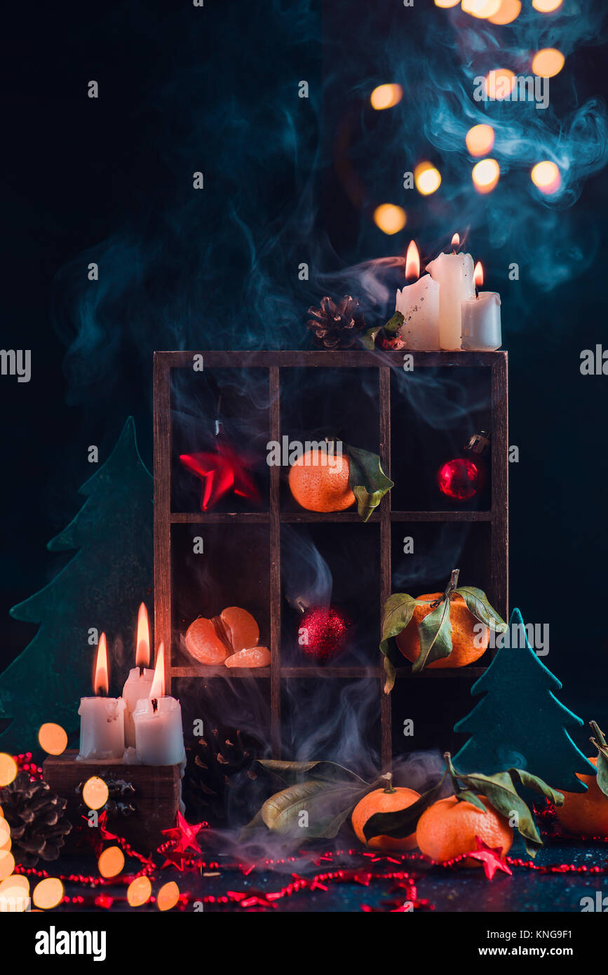 Christmas shadow box with tangerines, decorations, candles, pine cones ...