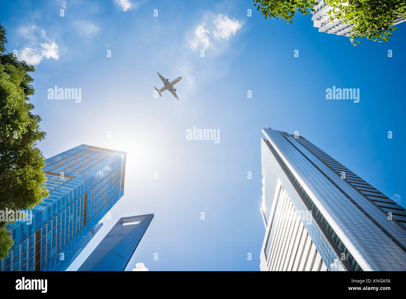 Airplane flying over business skyscrapers hi-res stock photography and ...