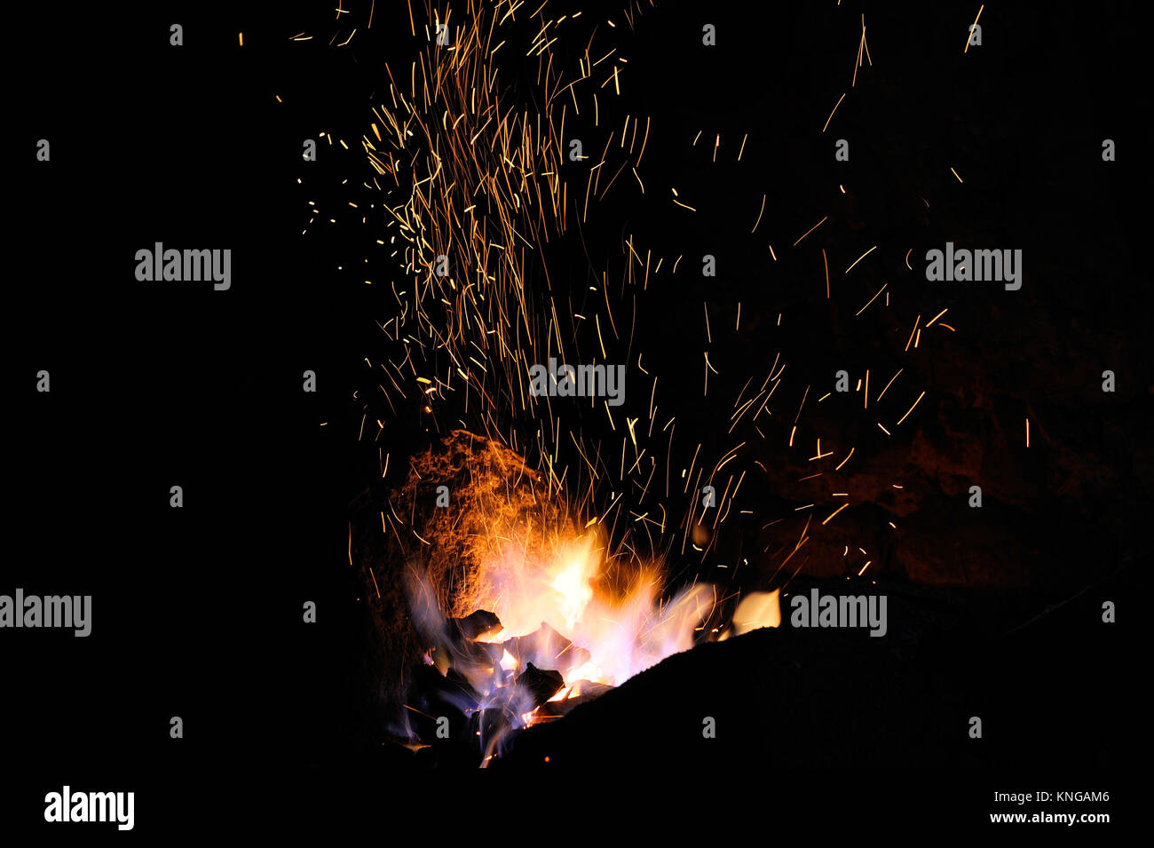 Sparks from the fire in the forge on dark background Stock Photo - Alamy