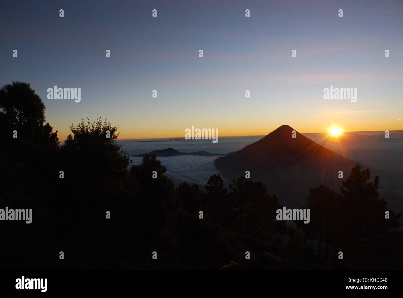 the sun rises behind the volcano Agua in Guatemala Stock Photo - Alamy