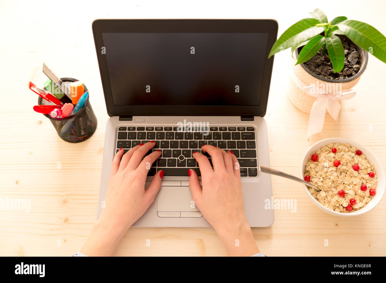 Healthy breakfast in front of computer laptop. oat porridge with ...