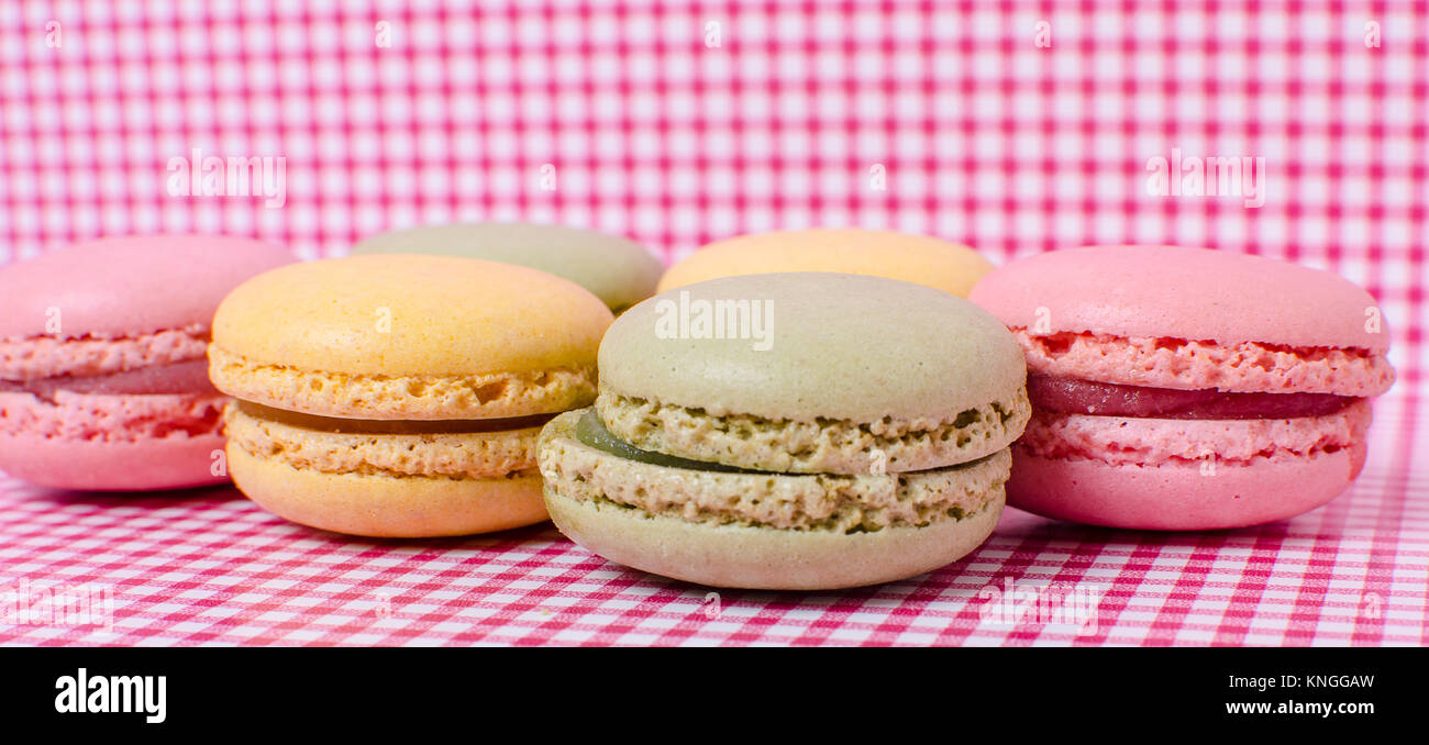 Colorful sweet macaroons on retro background Stock Photo - Alamy