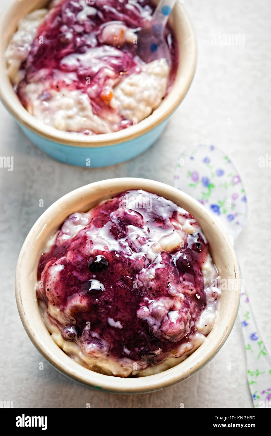 Rice pudding with blueberry sauce Stock Photo - Alamy