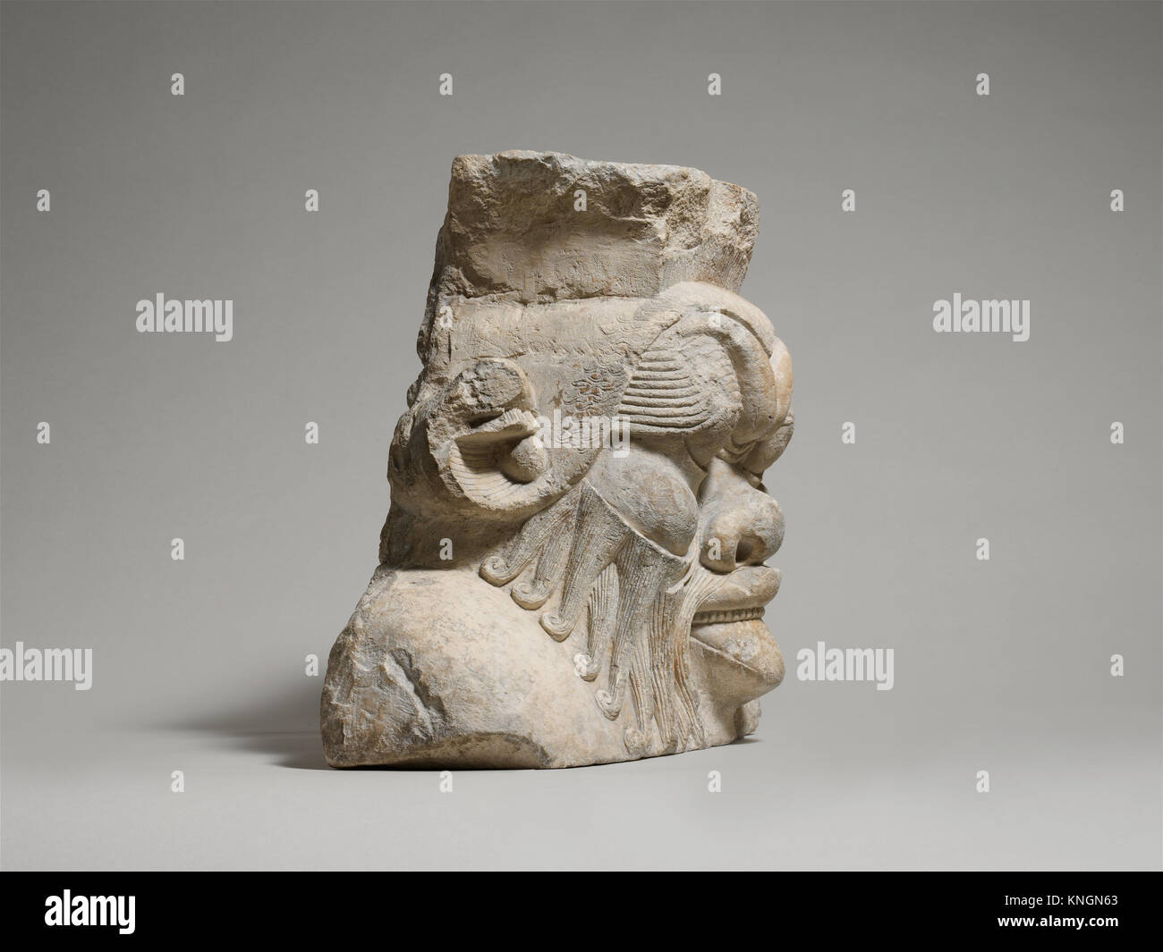 This column capital, shaped in the form of a Bes image, reflects ...