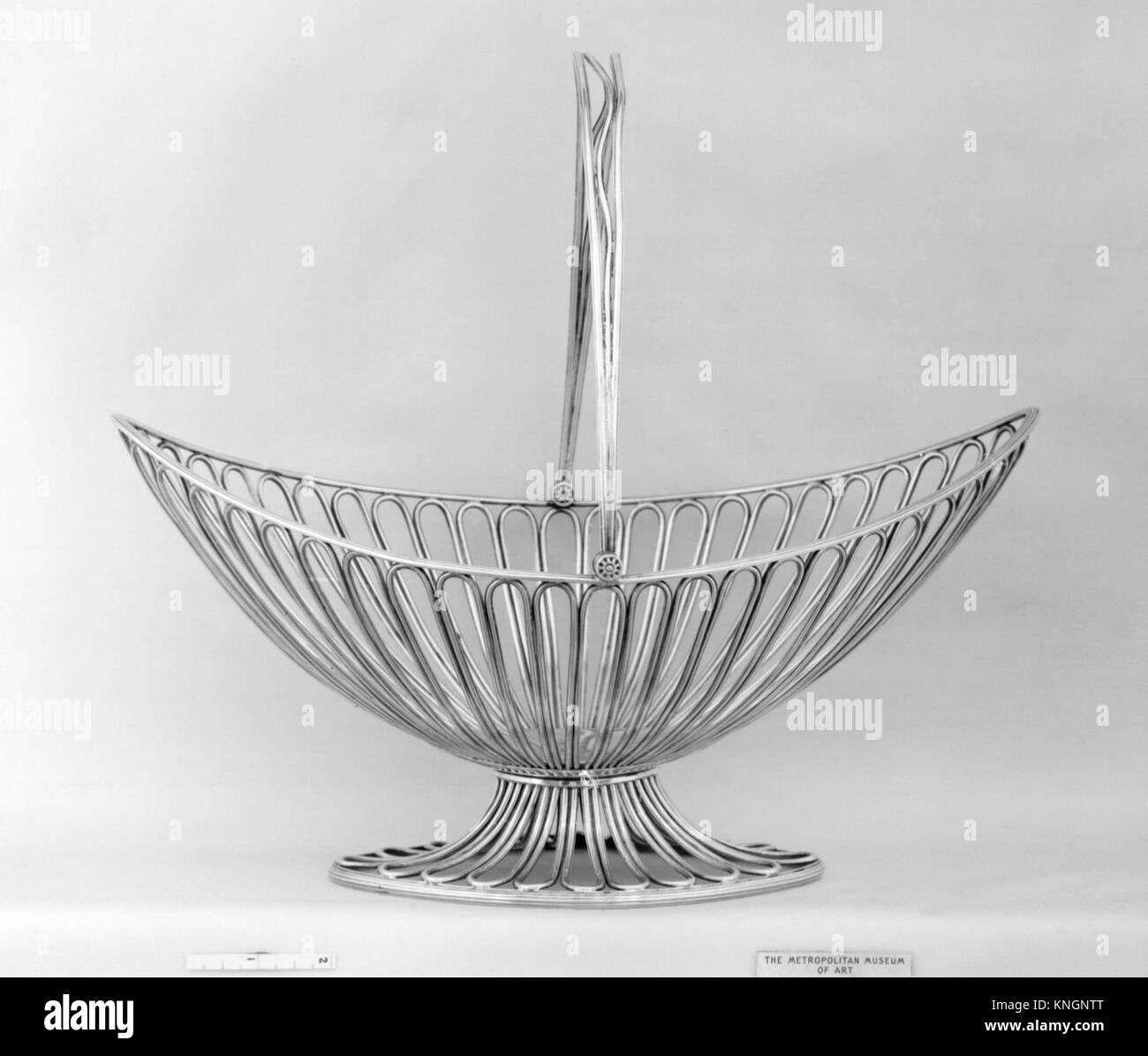 This cake basket exemplifies fine craftsmanship in metalwork, designed ...