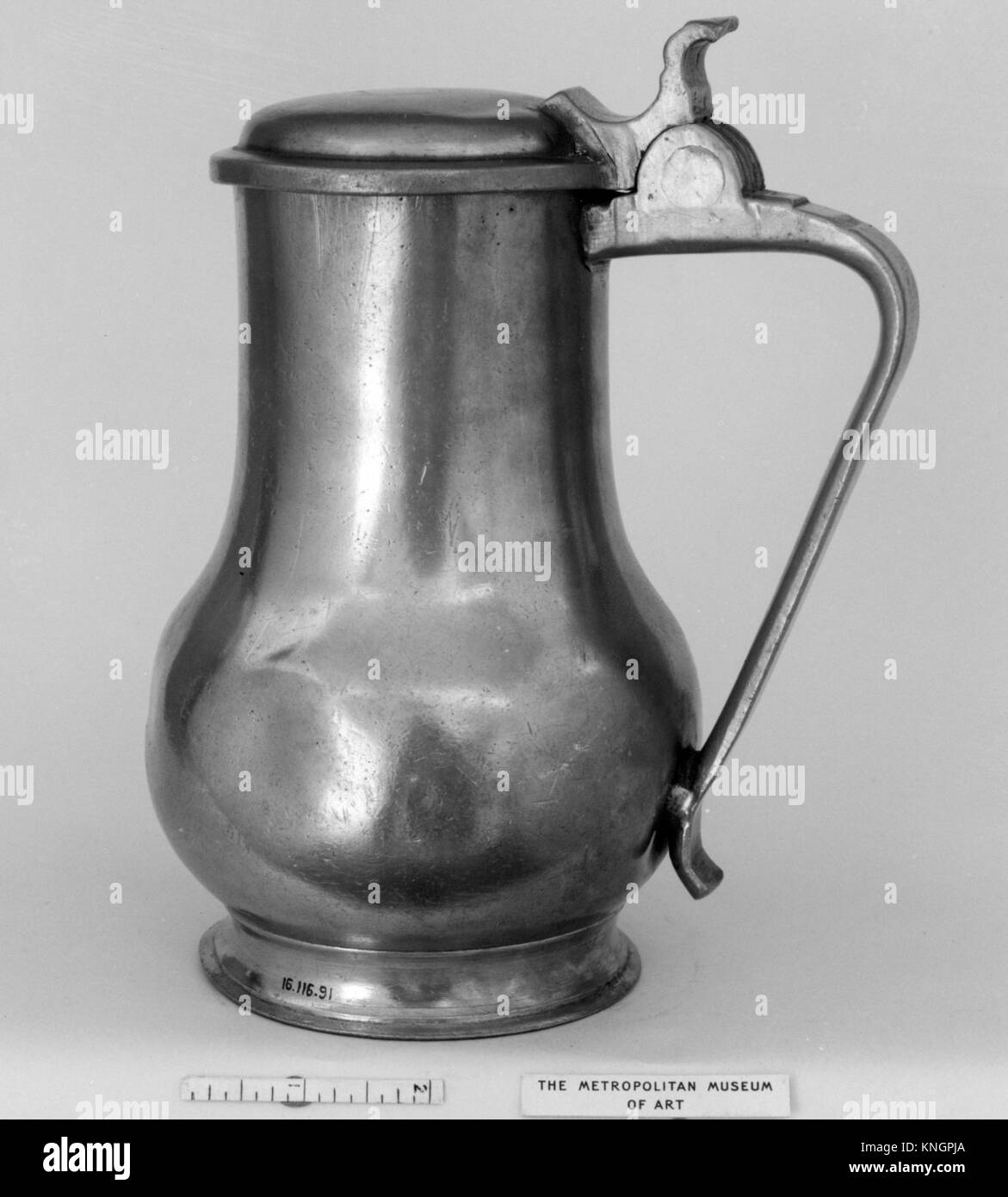 This flagon, made from metal, displays intricate design elements and ...