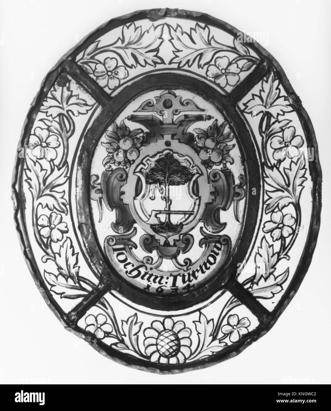 This armorial panel displays a heraldic design with a coat of arms ...