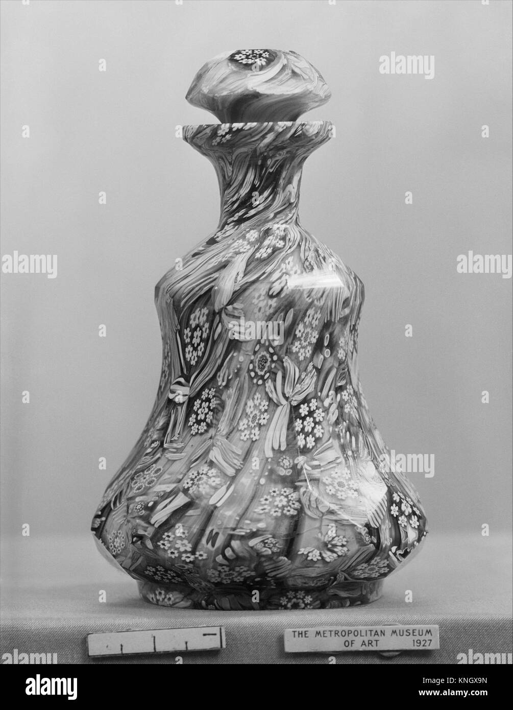 This bottle with stopper is a fine example of historical glassware ...