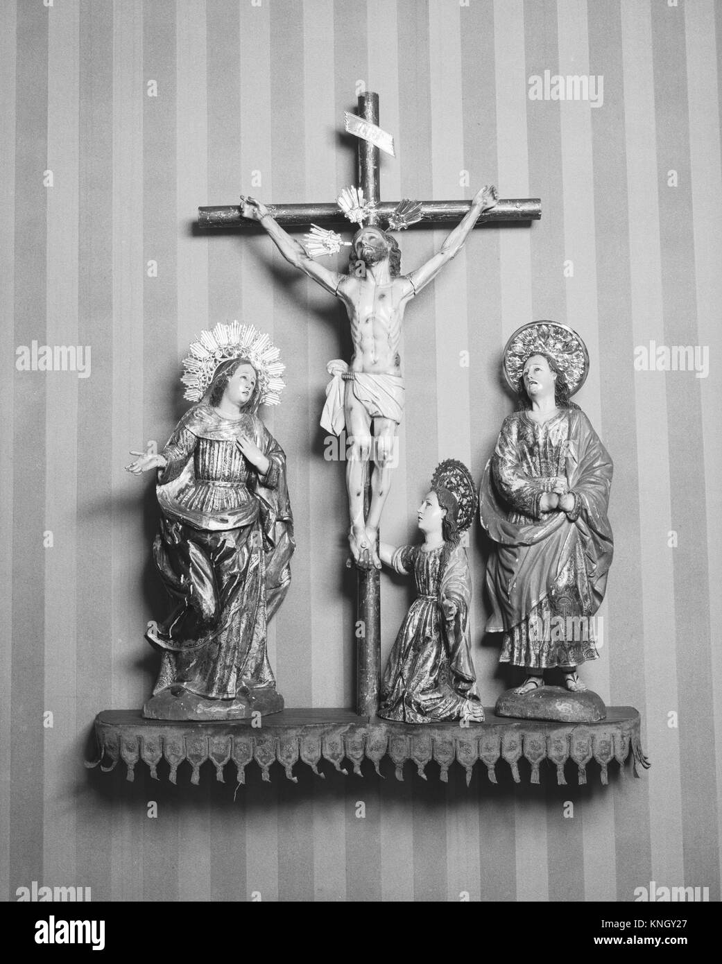 This sculpture of Christ on the cross is part of a Calvary group ...