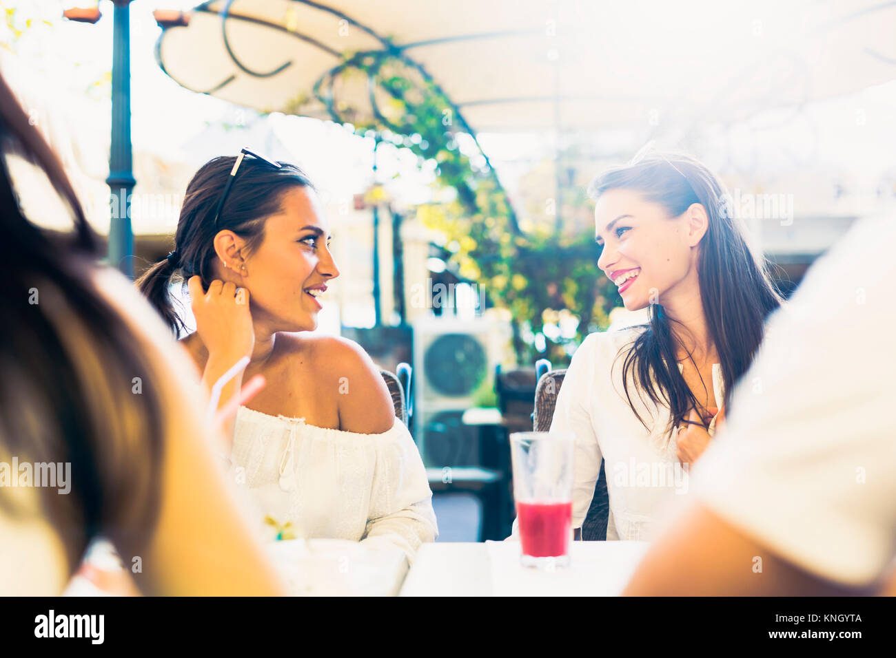 Two young girls talking during lunch break Stock Photo - Alamy