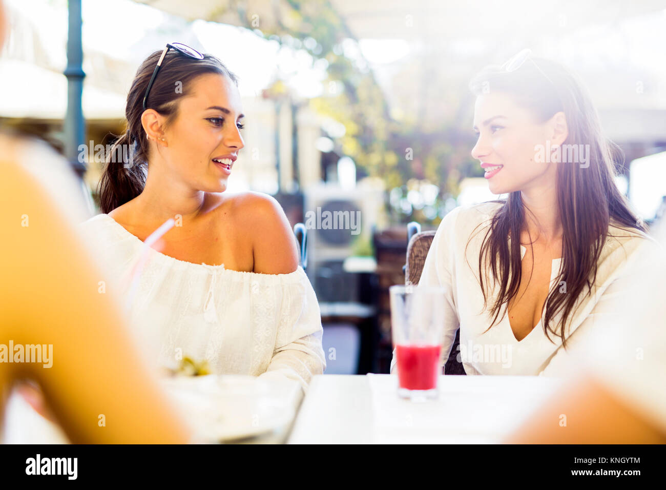Two young girls talking during lunch break Stock Photo - Alamy