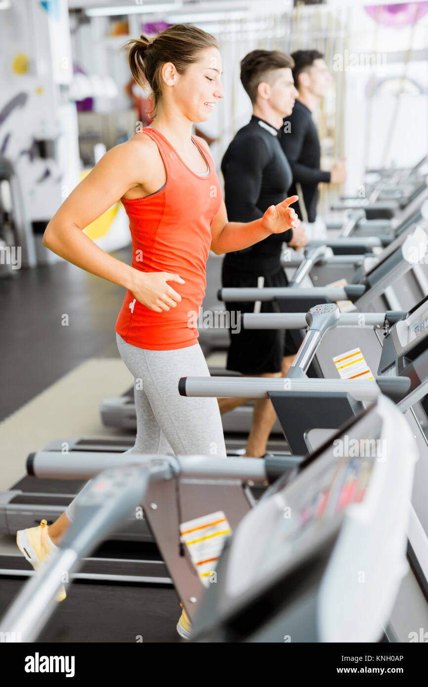 Group of young people using treadmills in a gym Stock Photo - Alamy