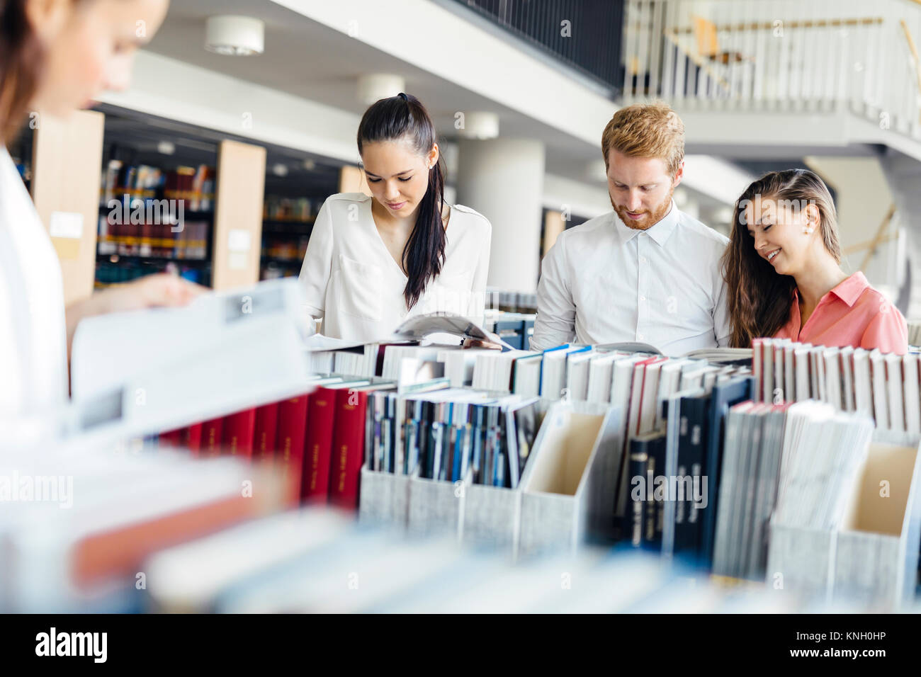 Group of students studying in library Stock Photo - Alamy