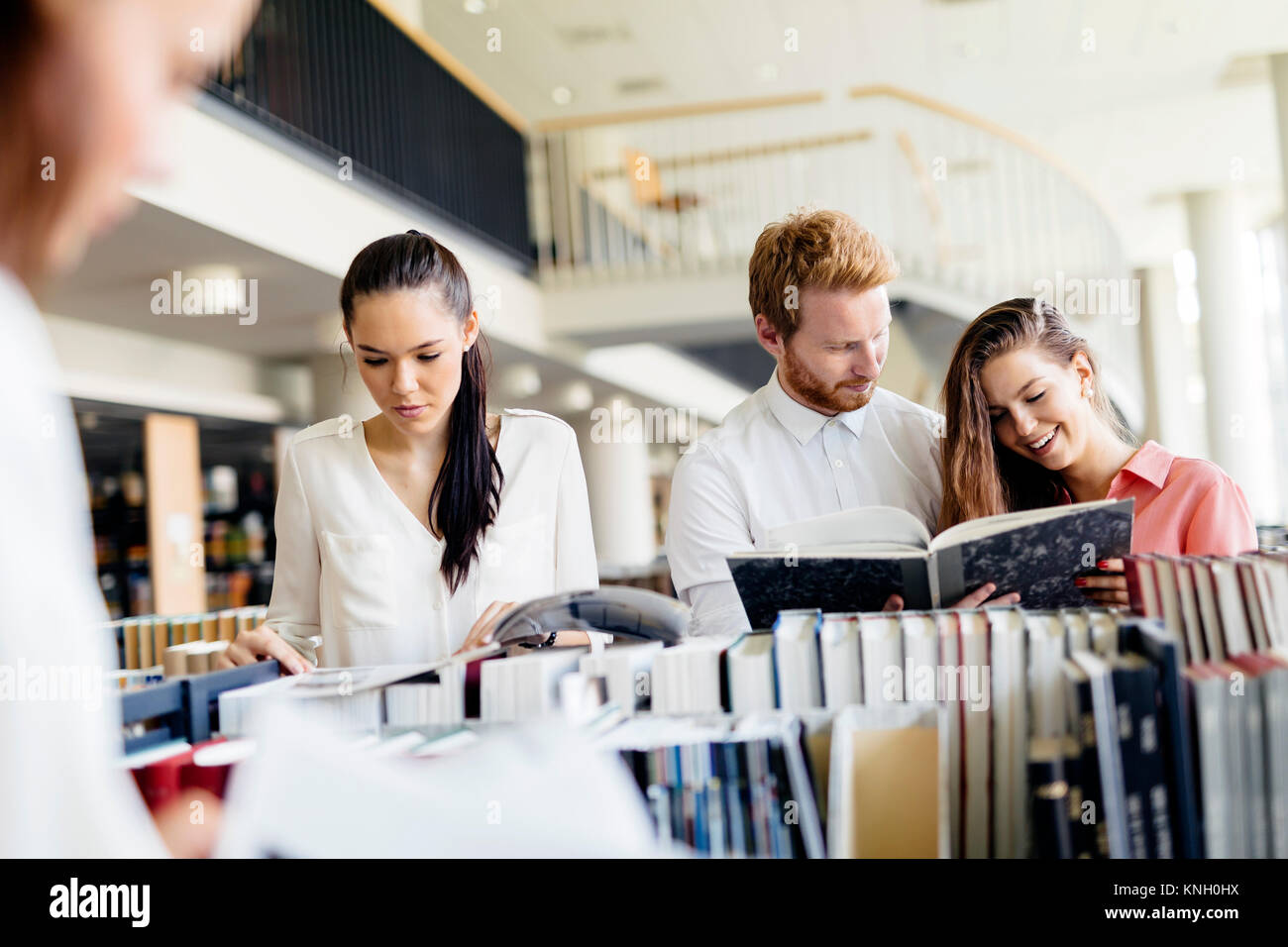 Group of students studying in library Stock Photo - Alamy