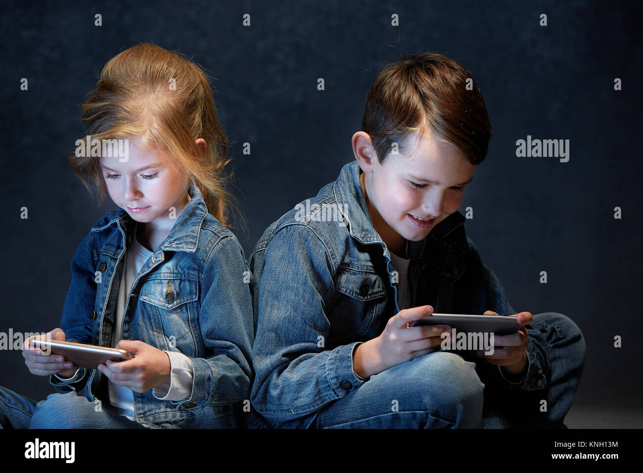 The studio shot of children with mobile phones Stock Photo - Alamy