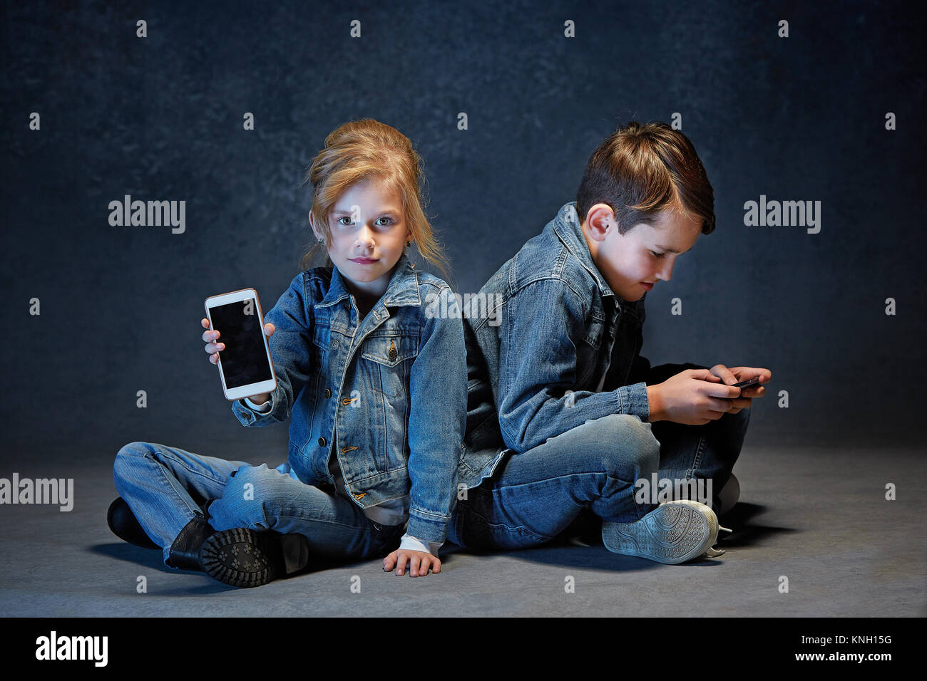 The studio shot of children with mobile phones Stock Photo - Alamy