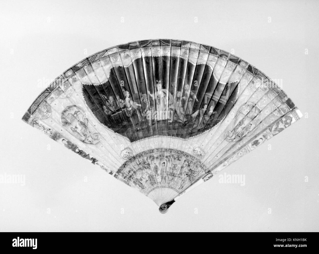 This fan features elaborate decoration, typically made from paper or ...