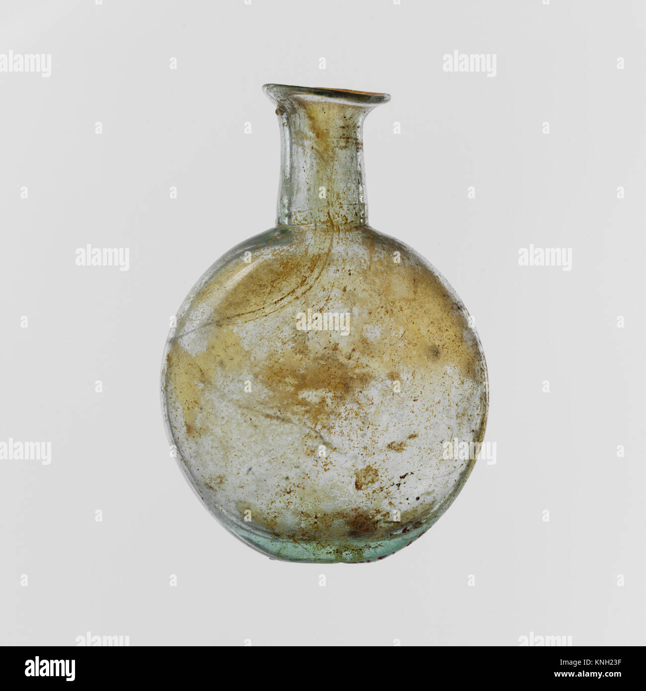 This glass lentoid bottle features a lenticular shape, known for its ...