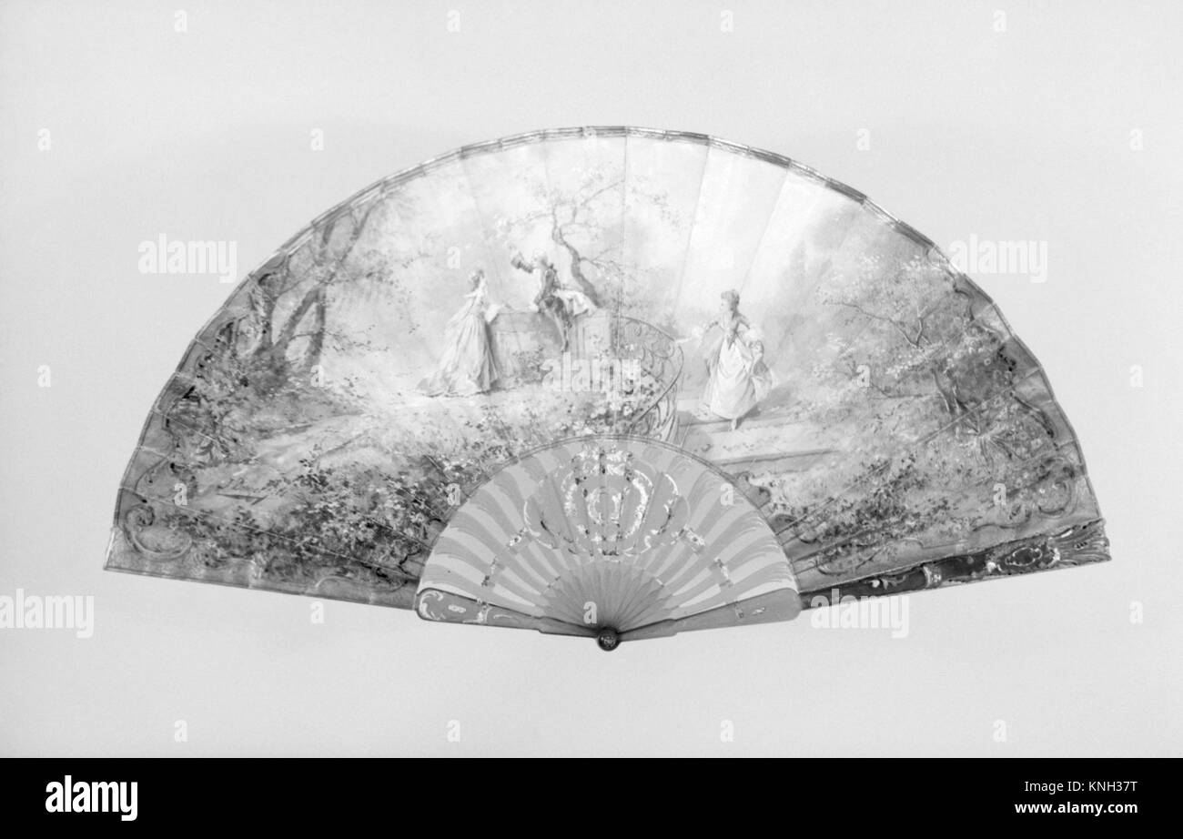 This fan, made from delicate materials, features intricate design work ...