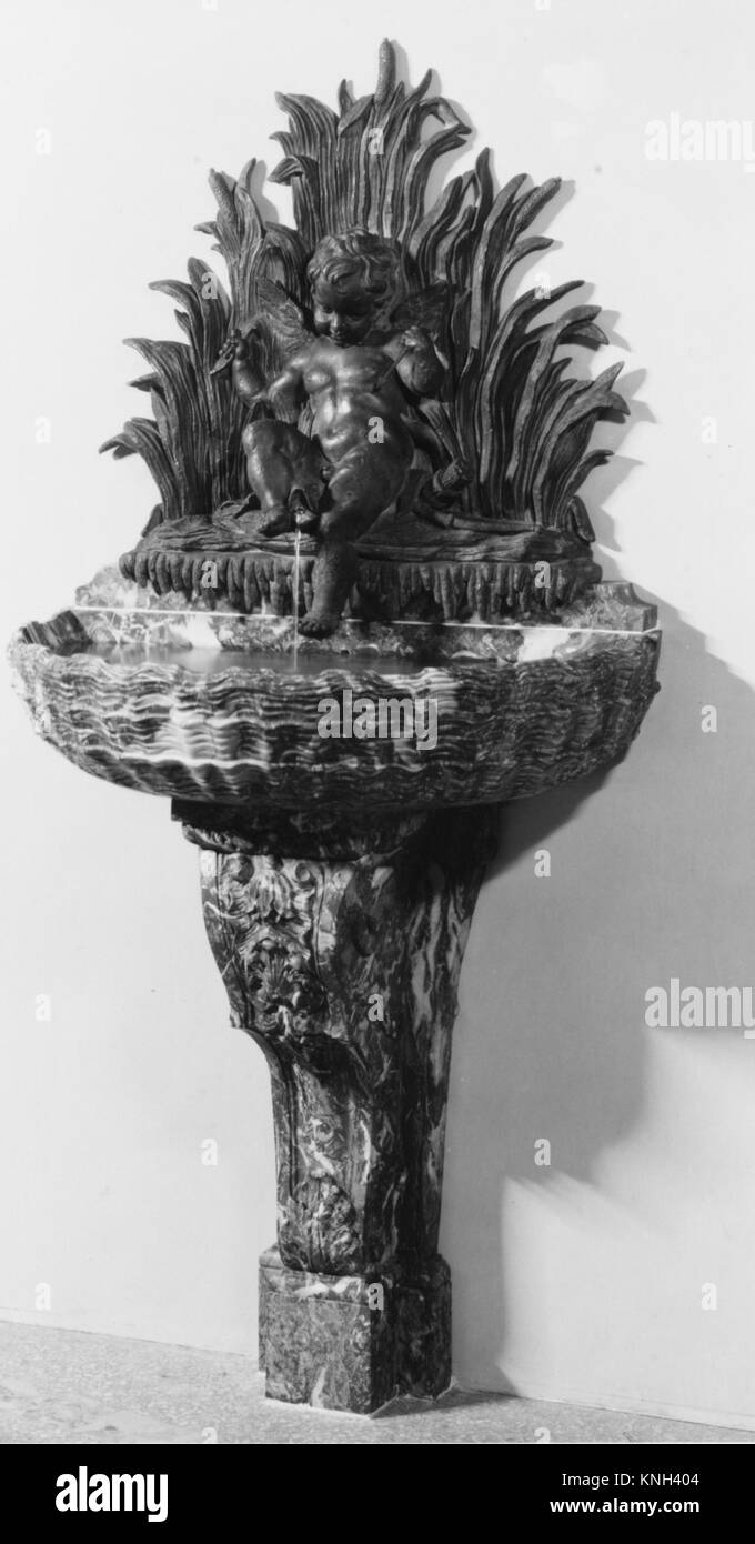 A sculpture depicts Cupid, the Roman god of love, with a dolphin ...