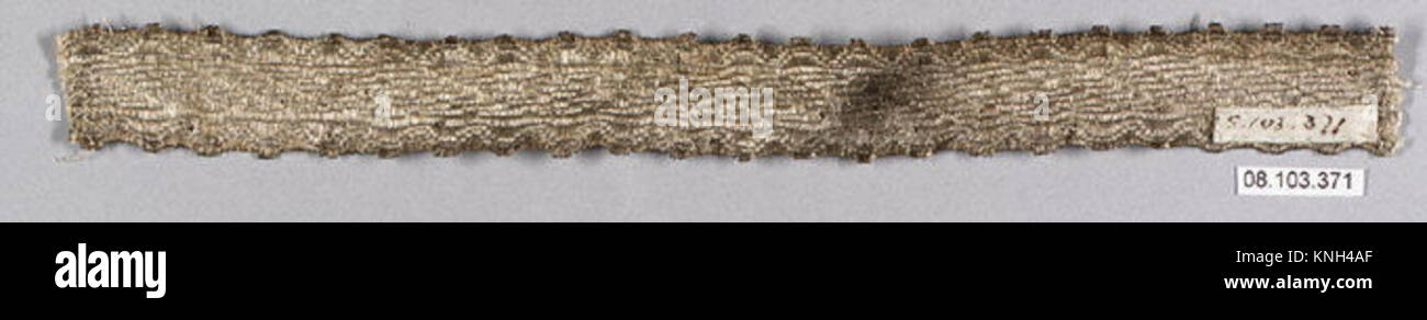 A narrow decorative woven band, known as a galloon, typically used in ...