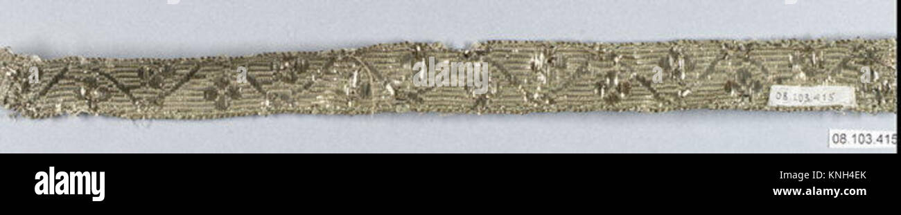 This Galloon is a decorative trim or lace, often used in textile and ...