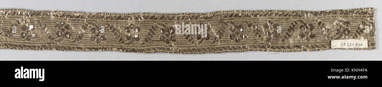This galloon, a decorative trim used in garment construction, showcases ...
