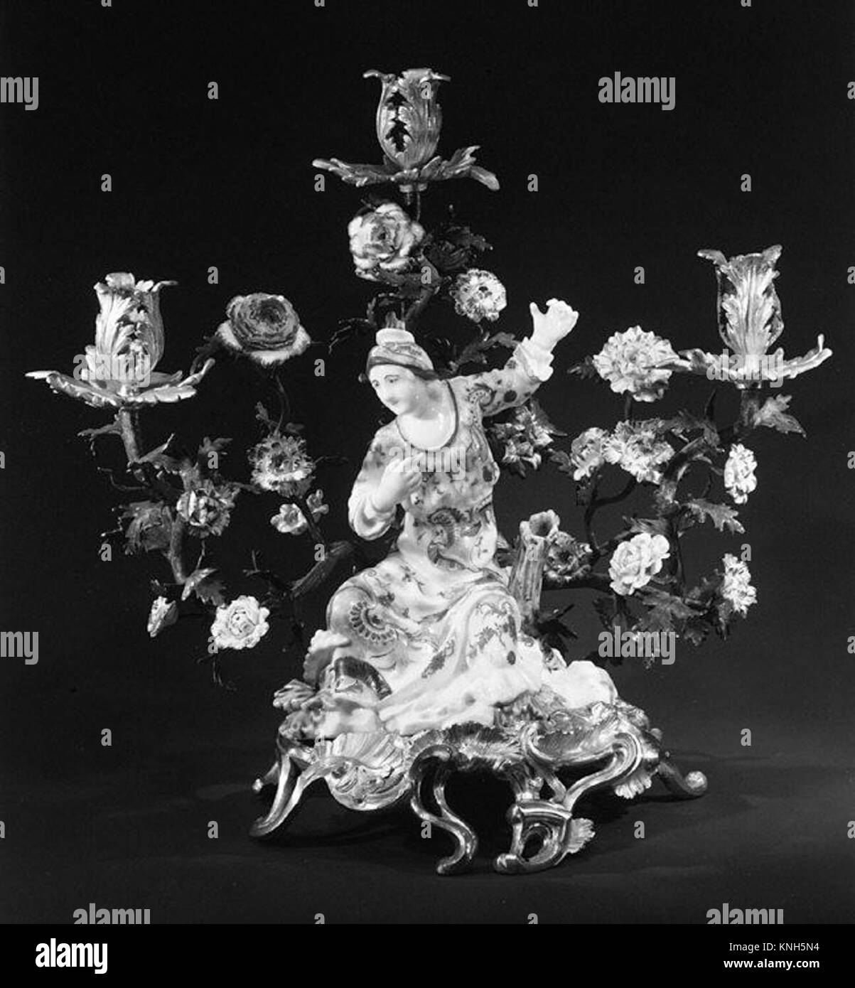 This figure, mounted as a candelabrum, combines both sculpture and ...