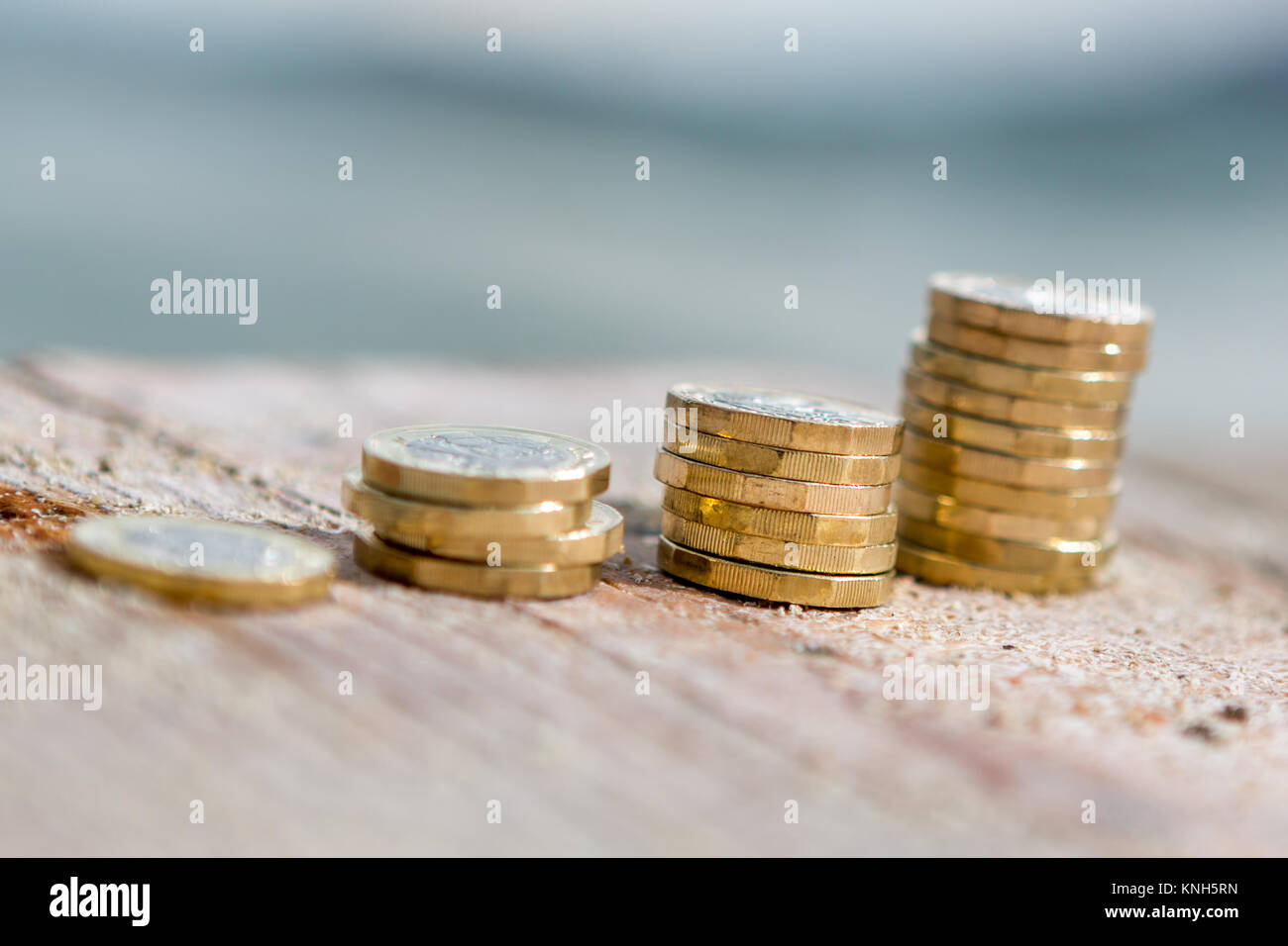 Picture of four piles of British pound coins. Money, New Pounds in a ...