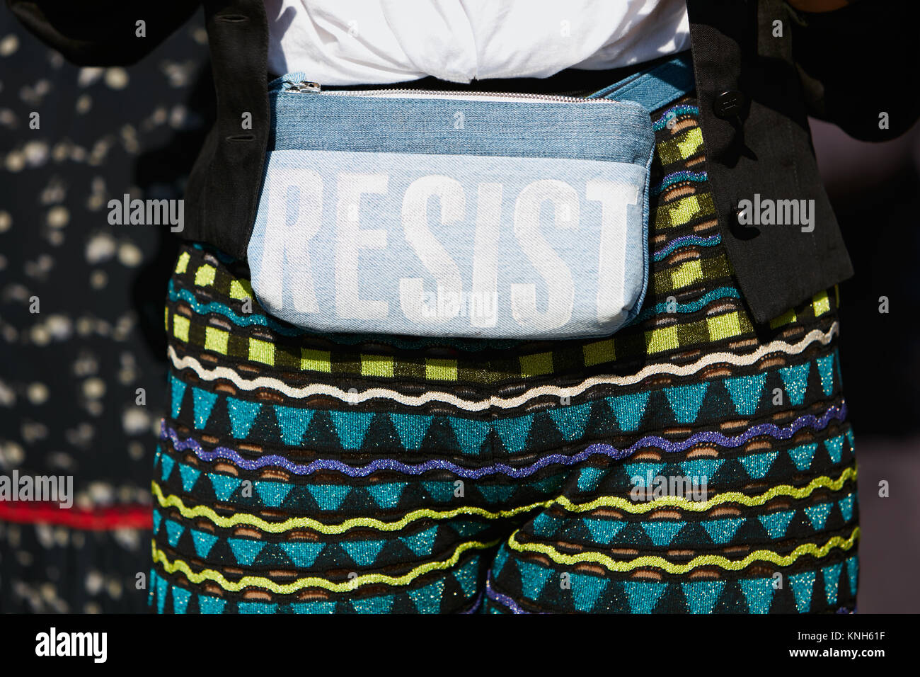 MILAN - SEPTEMBER 24: Woman with blue jeans pouch with 'Resist' writing ...
