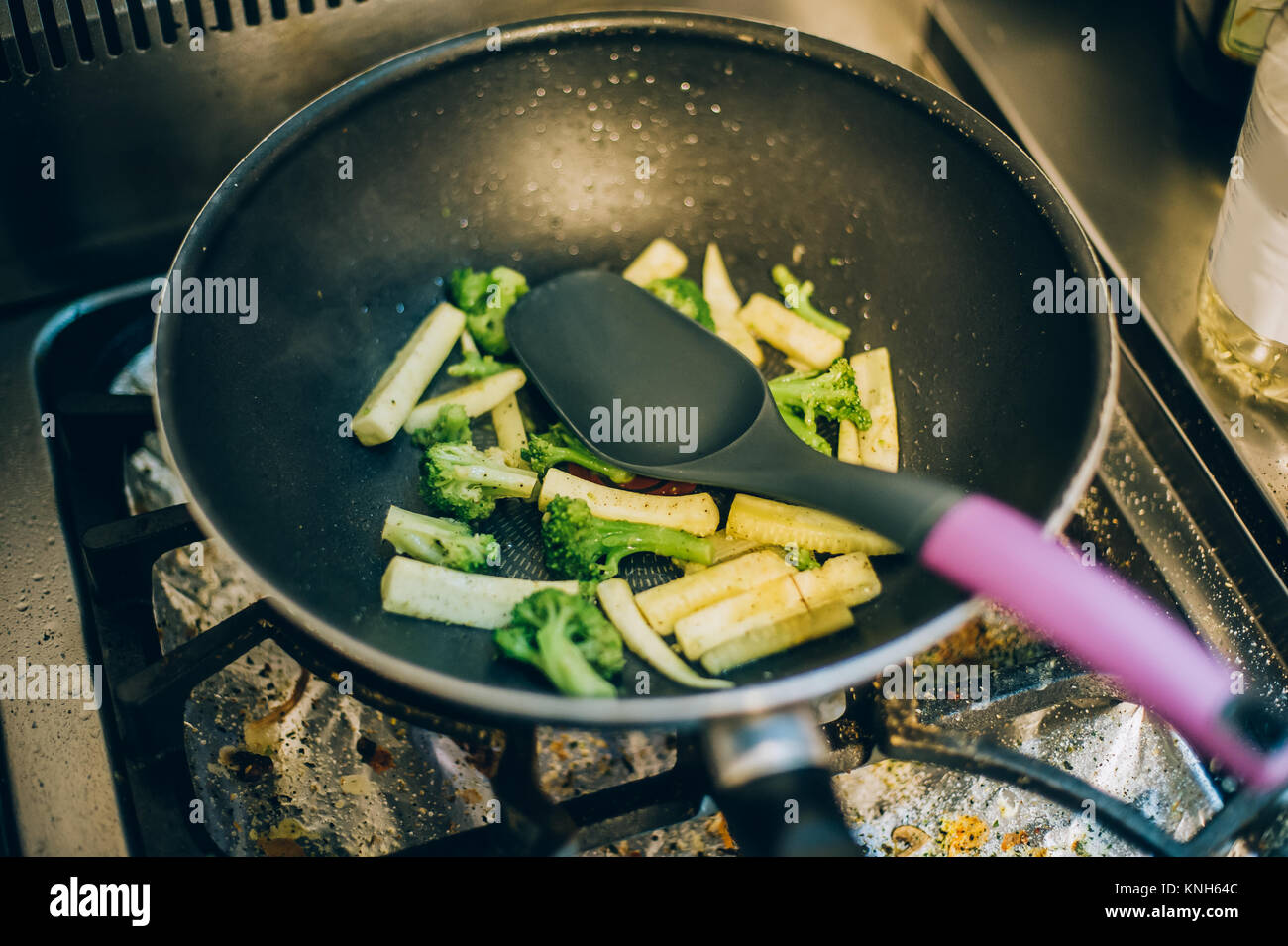 Preparing food in the frying pan. Kitchen in the fast food restaurant ...