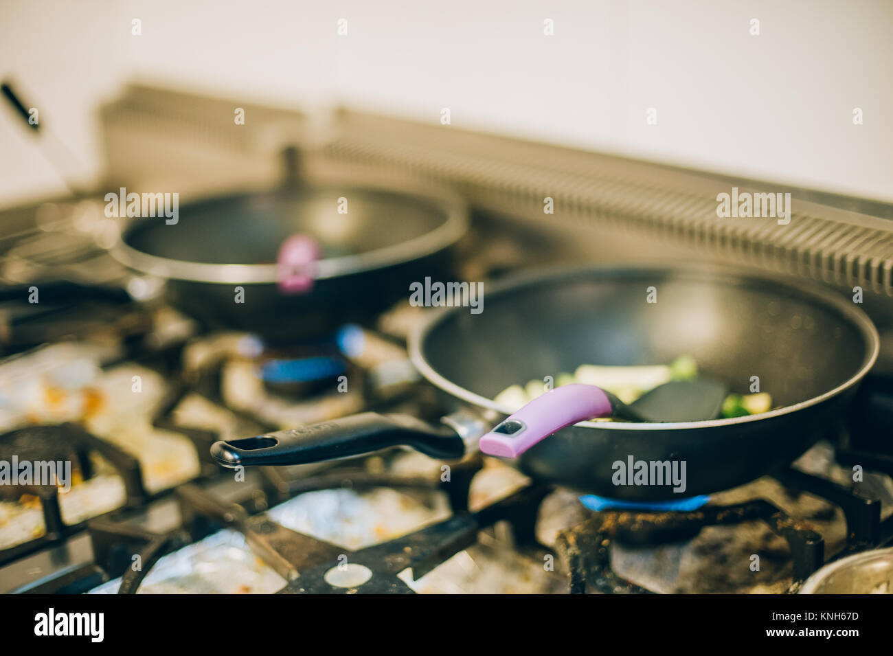 Two frying pans on the stove in the kitchen. Preparing food in the ...