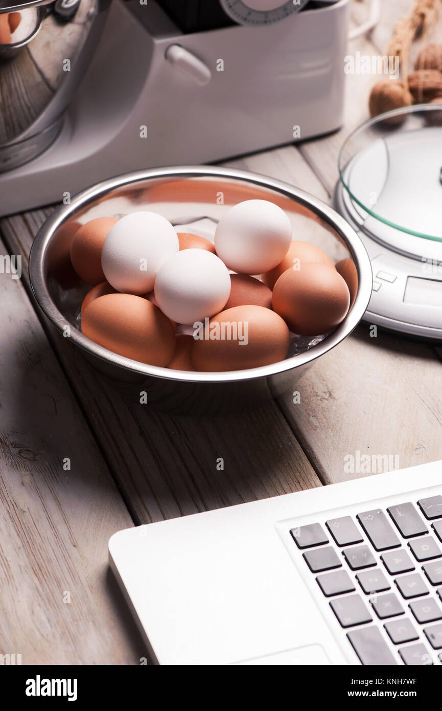Eggs scale and laptop. On line recipe concept Stock Photo - Alamy