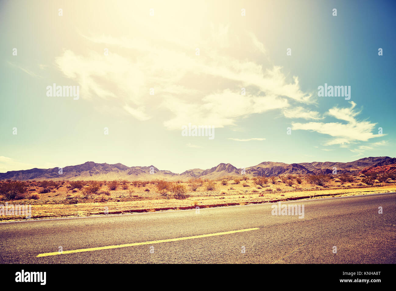 Vintage toned picture of a desert road at sunset, travel concept ...