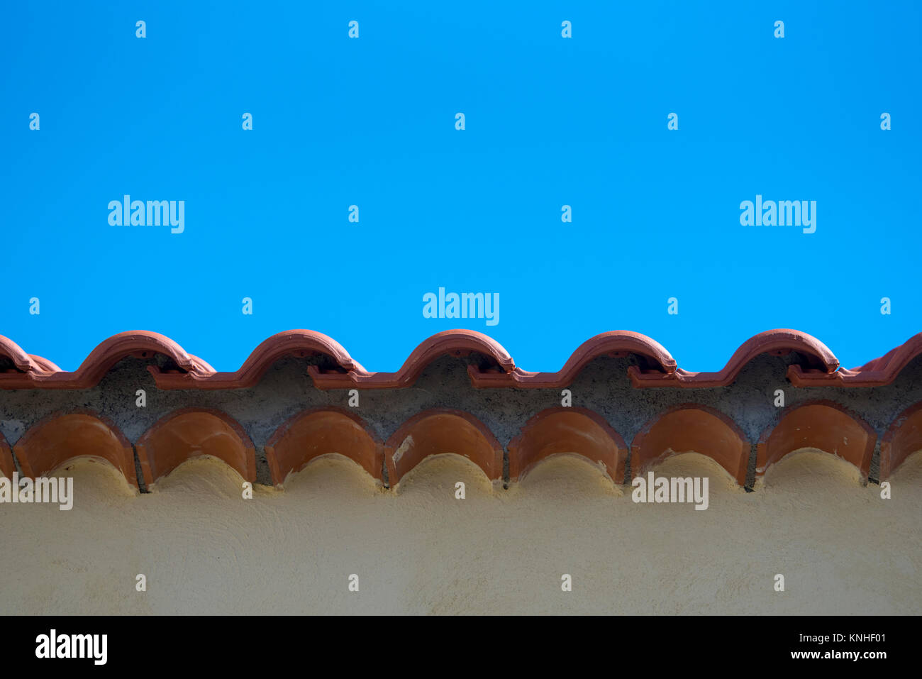 red curved tile ends against a blue sky Stock Photo - Alamy