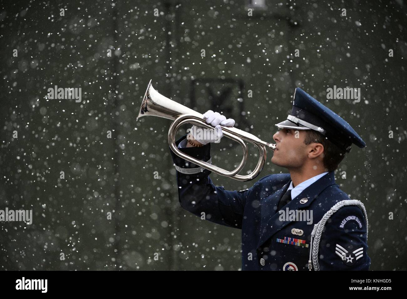 A U.S. soldier plays Taps on a bugle in the snow during a training ...