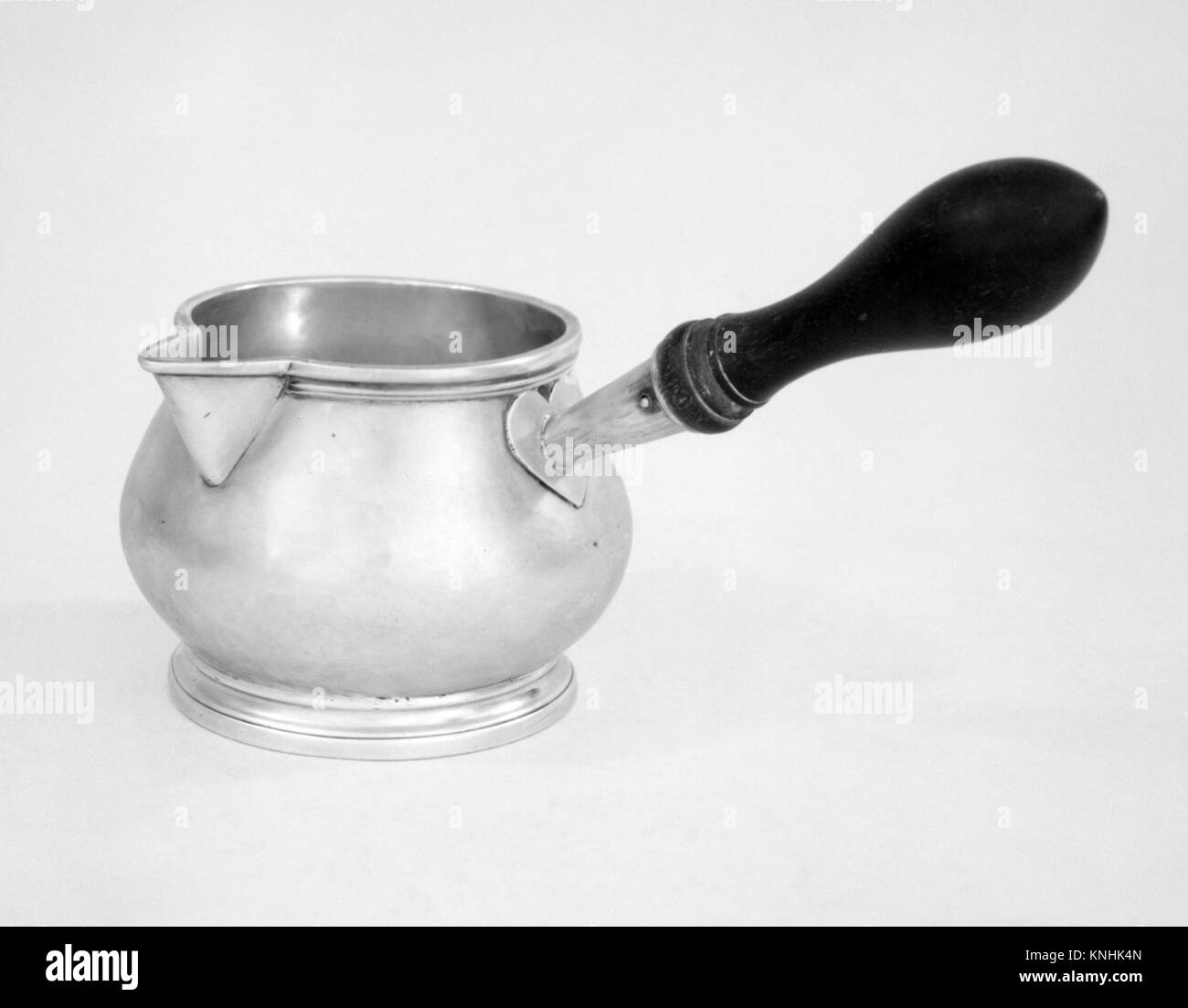 This brandy warmer, designed to heat liquor, exemplifies both ...