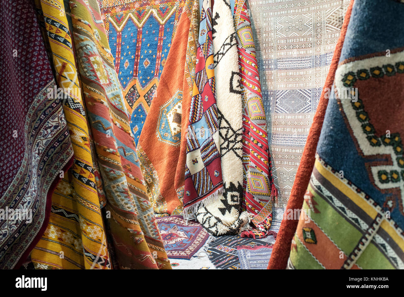 Background pattern and texture of assorted colorful woven textiles in a ...