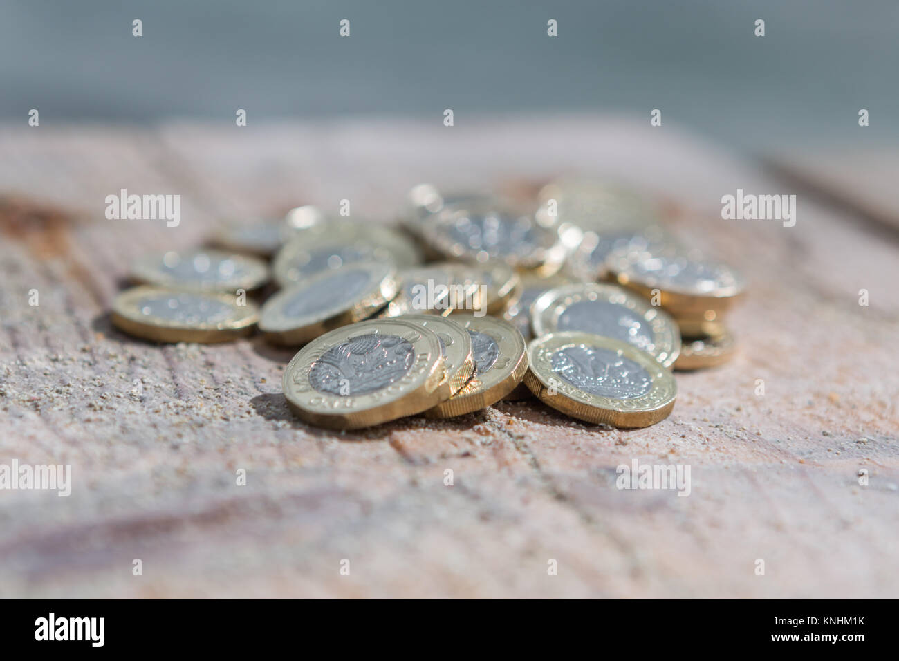 Pile of New British Pound Coins on the wood. New Pounds in a Warm ...