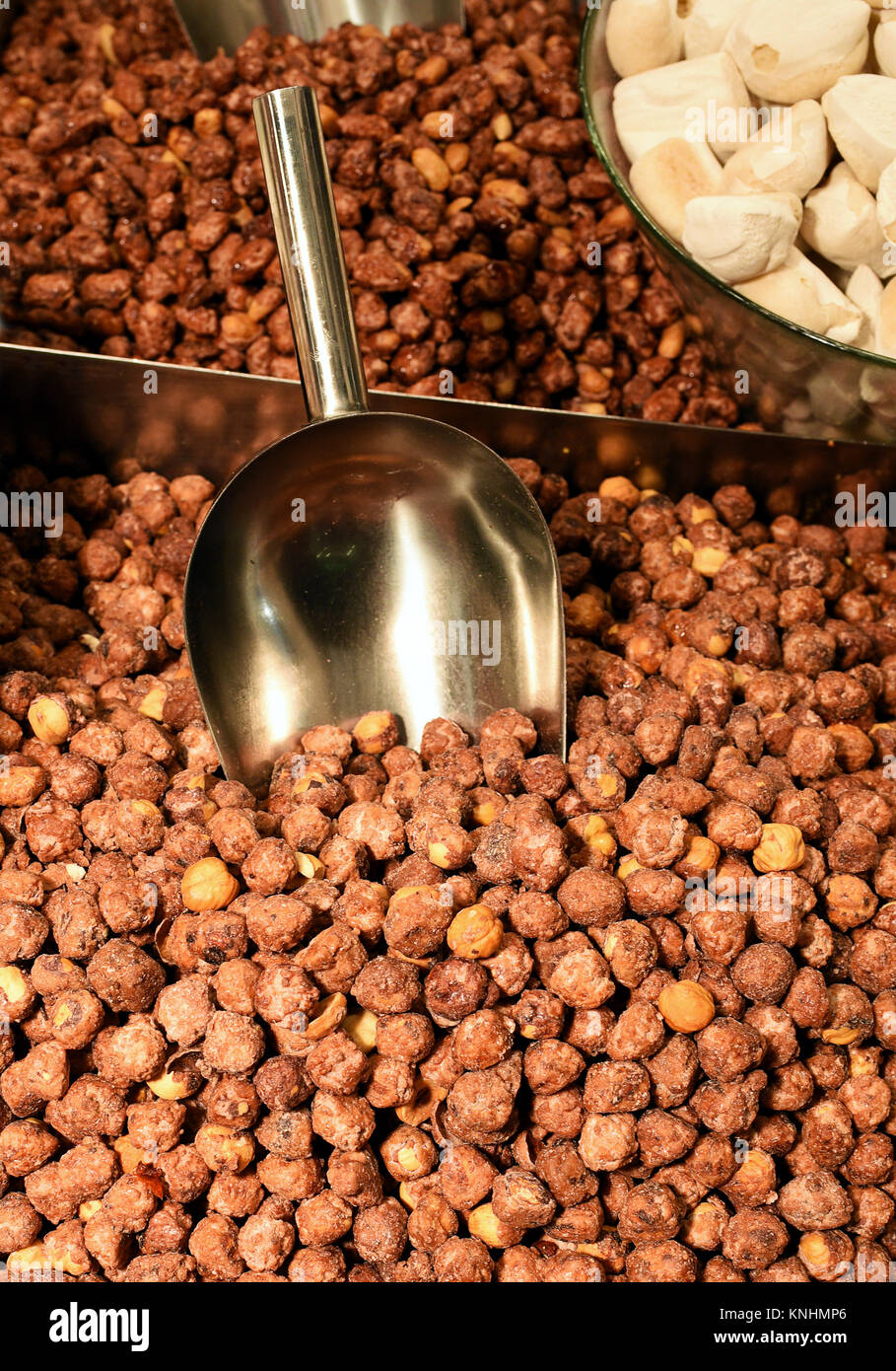 Sugared peanuts in a bin with metal scoop on display for sale in a shop ...