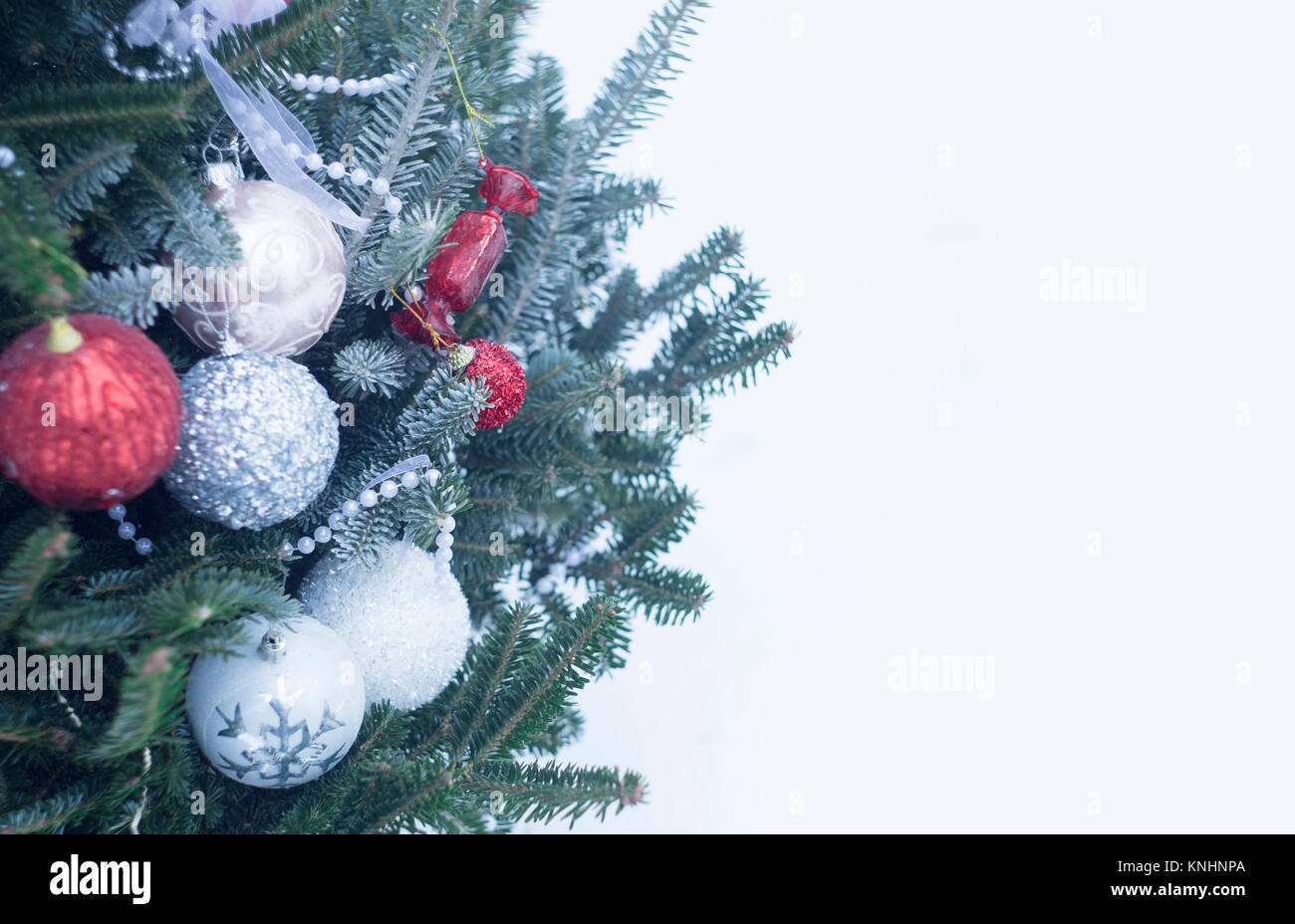 A festive mood with beautifully decorated Christas tree against white ...