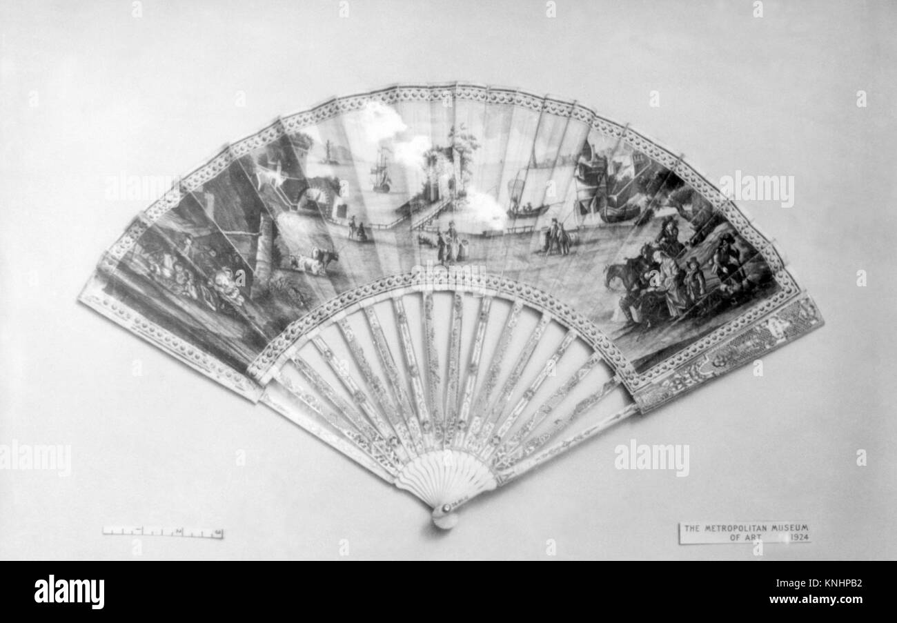 This fan, made from delicate materials, showcases the intricate ...