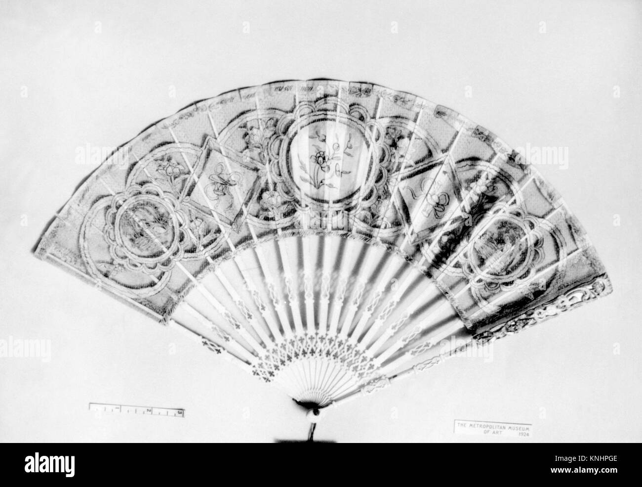 This fan, crafted from delicate materials, showcases intricate design ...