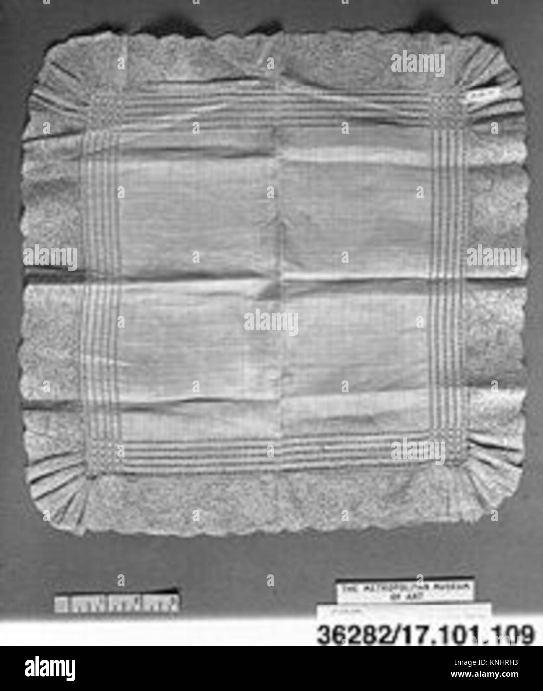 This handkerchief, crafted from fine textile, showcases the delicate ...