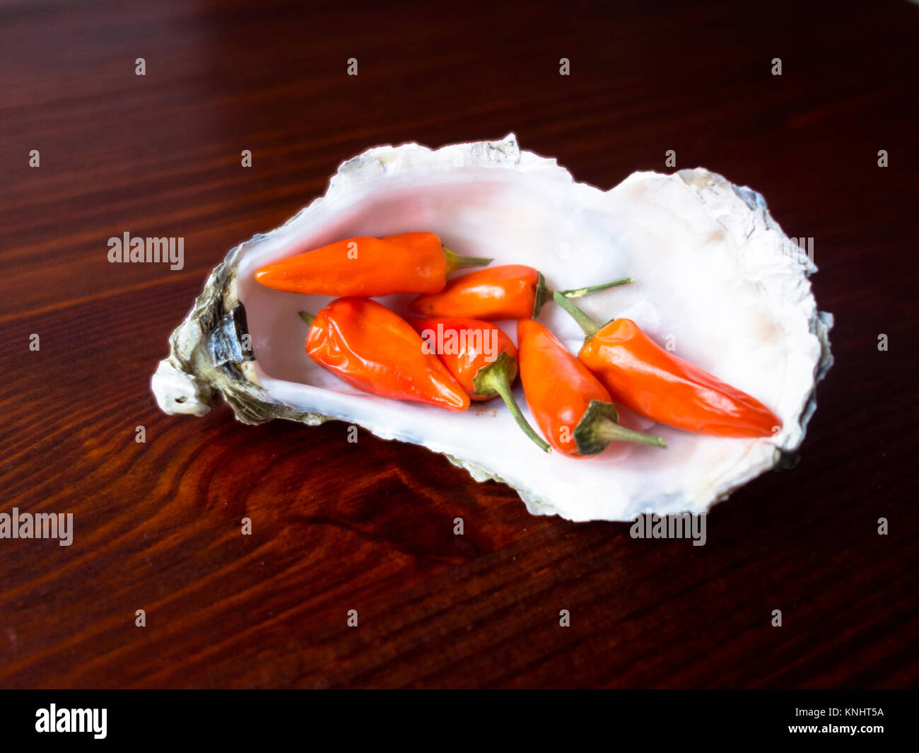 Baby chili peppers inside an oyster shell Stock Photo - Alamy